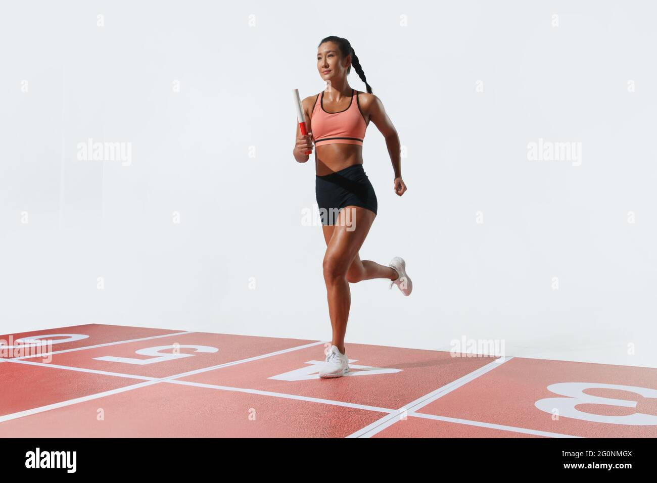 Female athletes relay race Stock Photo - Alamy