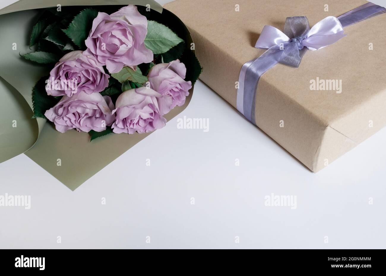 Bouquet from violet roses with gift box on the white background, top ...