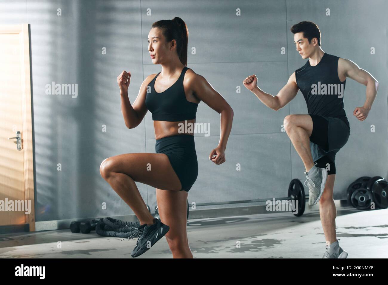 Young people exercise in the gym Stock Photo - Alamy