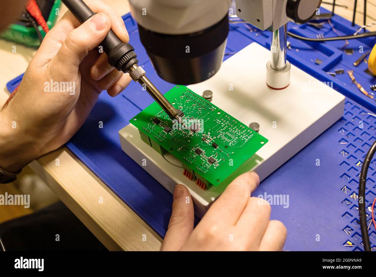 Soldering process on a green PCB close up Stock Photo - Alamy