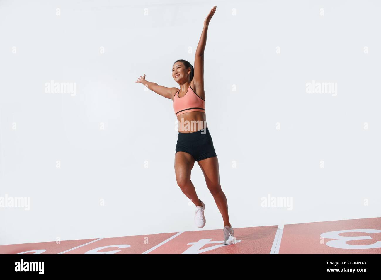 Female athlete sprint ran to the finish Stock Photo - Alamy