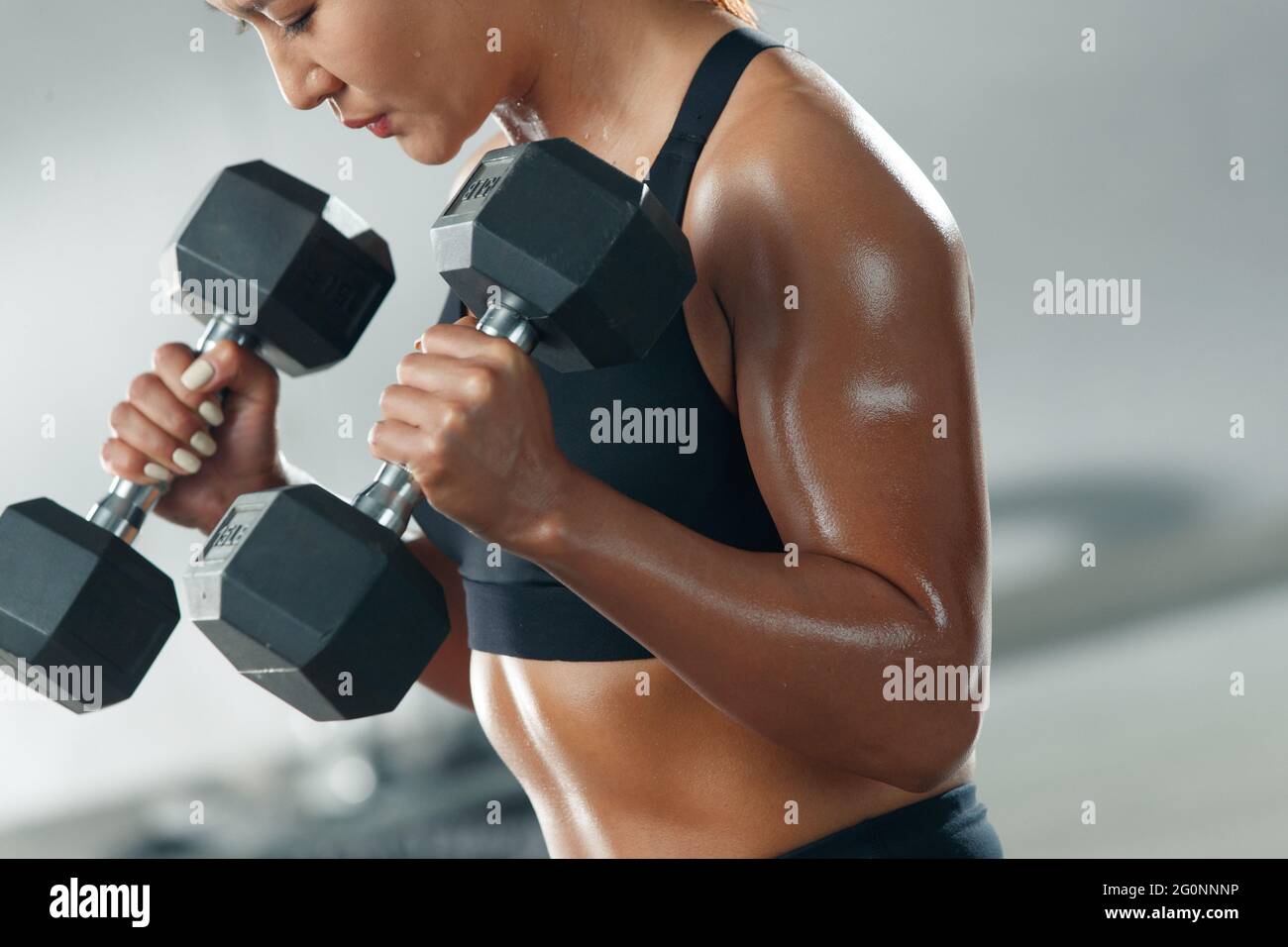 Young women at the gym dumbbell Stock Photo - Alamy