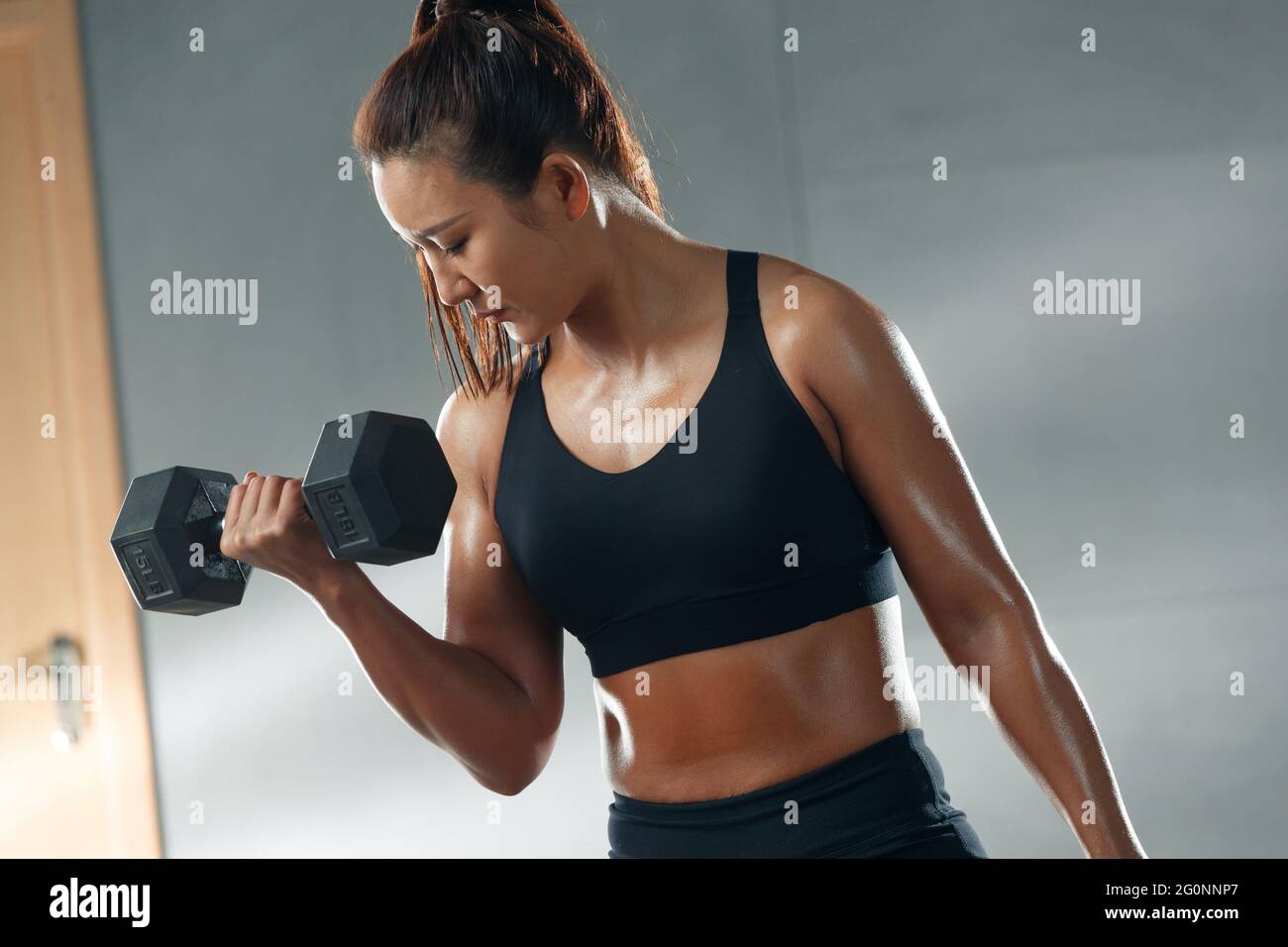 Young women at the gym dumbbell Stock Photo - Alamy