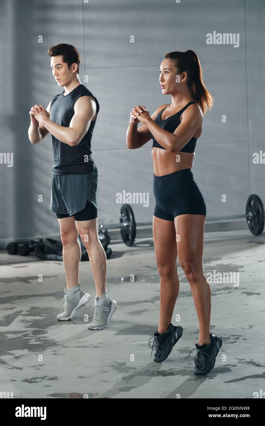 Young people exercise in the gym Stock Photo - Alamy