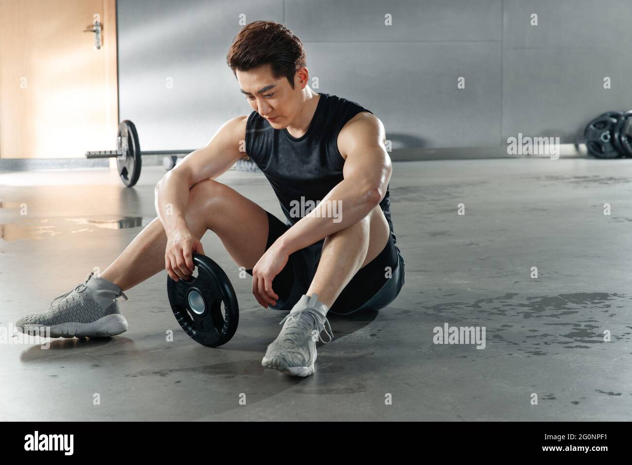 The young man at the gym weight training Stock Photo - Alamy
