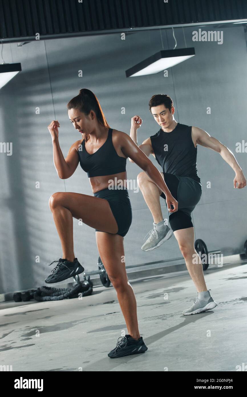 Young people exercise in the gym Stock Photo - Alamy