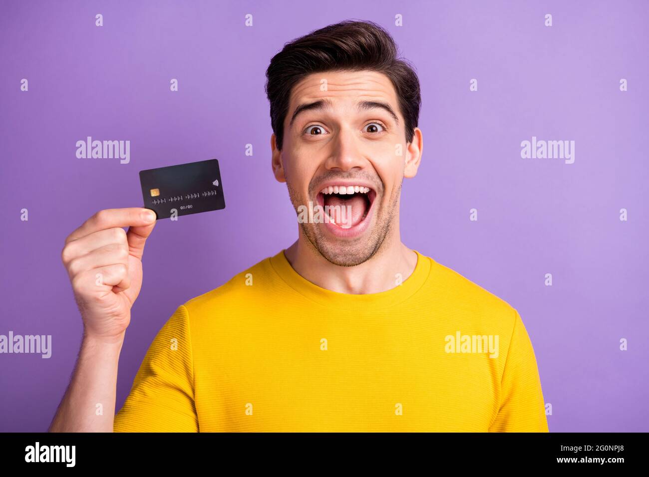 Photo of impressed handsome person hand hold debit card open mouth ...