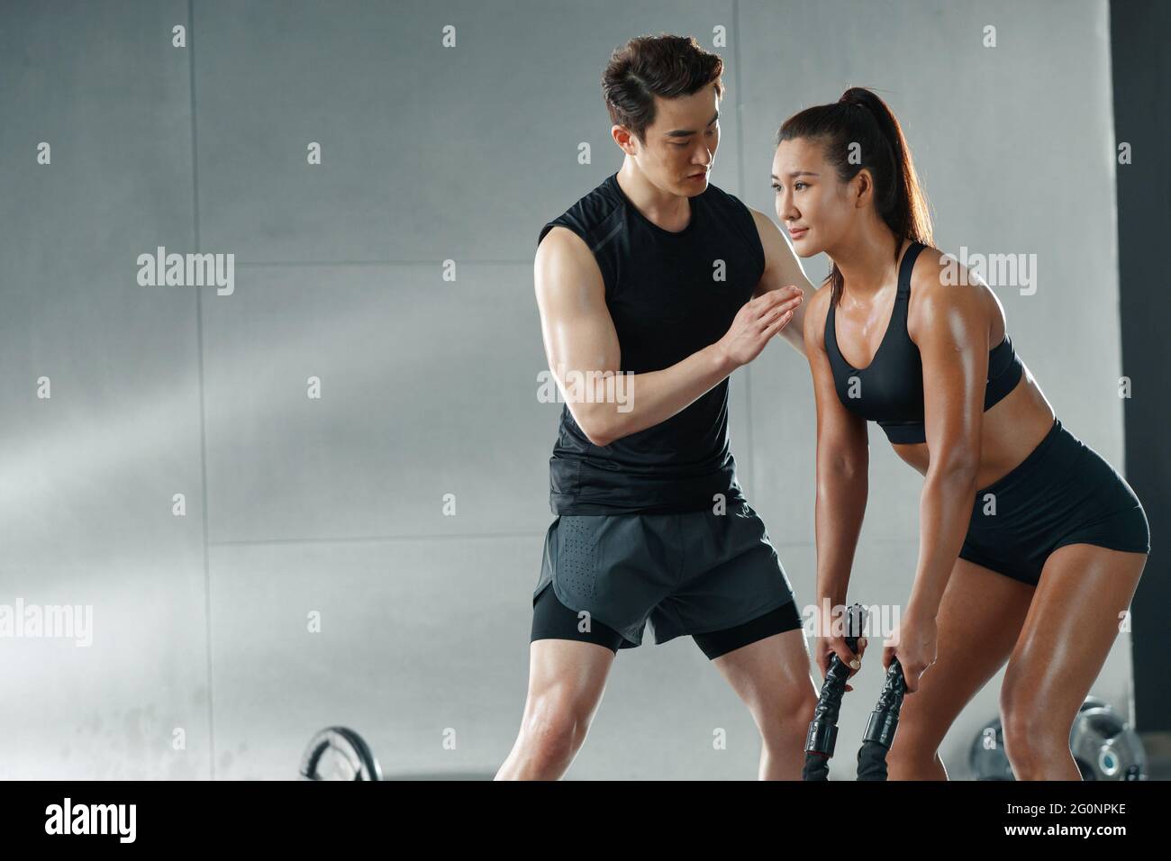 Fitness coaching young woman Stock Photo - Alamy