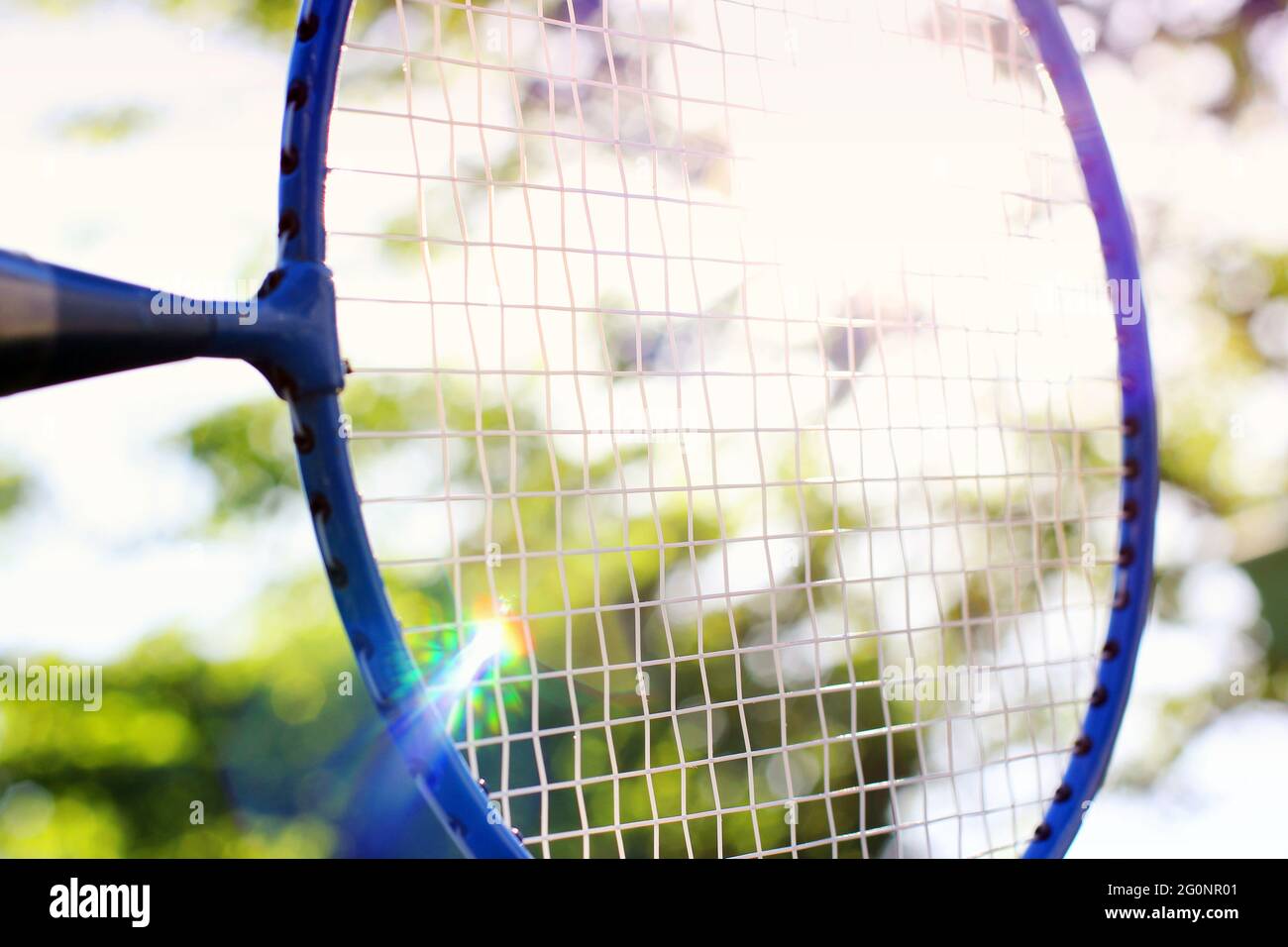 Badminton racket close up against a background of trees Stock Photo - Alamy