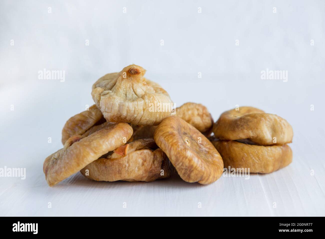 Sun-dried figs close-up on a light background Stock Photo - Alamy
