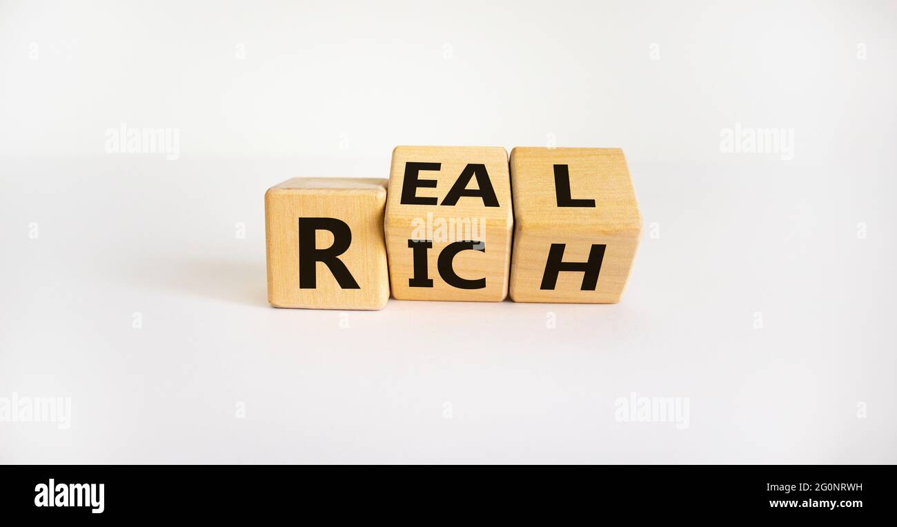 Real rich symbol. Turned wooden cubes with words 'Real rich'. Beautiful ...