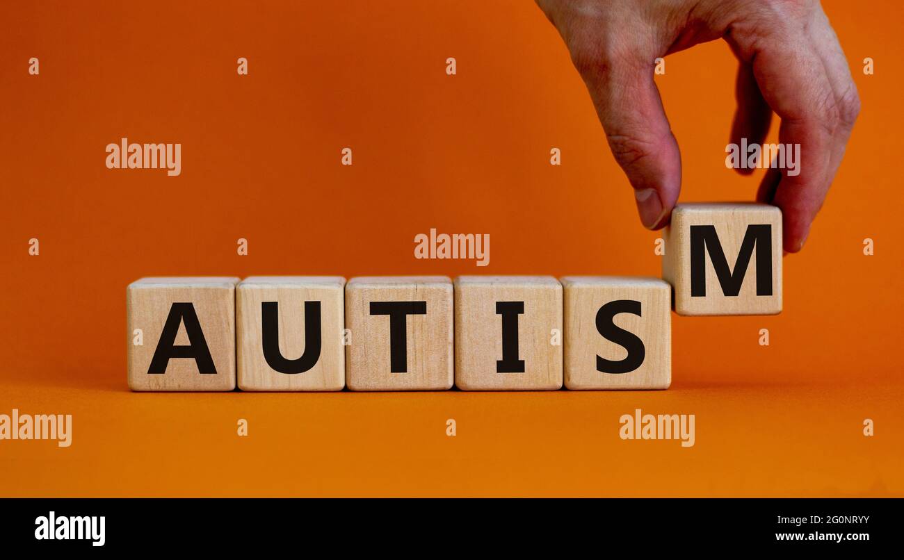 Autism symbol. Doctor holds cubes with the word 'autism'. Beautiful ...