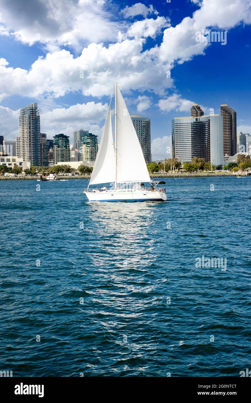 Sailboat in San Diego Bay passing the downtown skyscrapers of San Diego ...