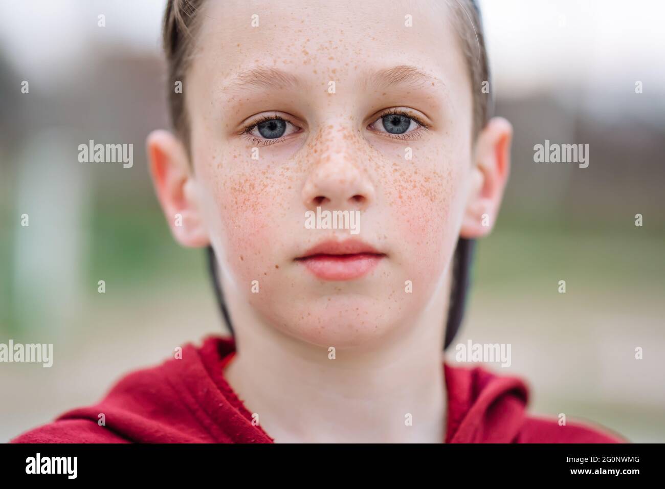 Close-up portrait of teenage serious boy with freckles on his face ... Close-up portrait of teenage serious boy with freckles on his face ...