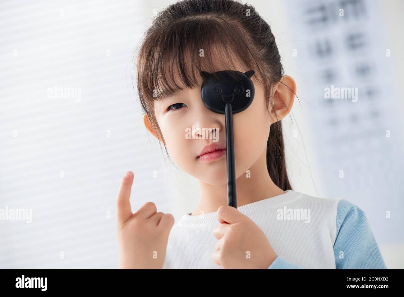 Lovely little girl test visual acuity Stock Photo - Alamy