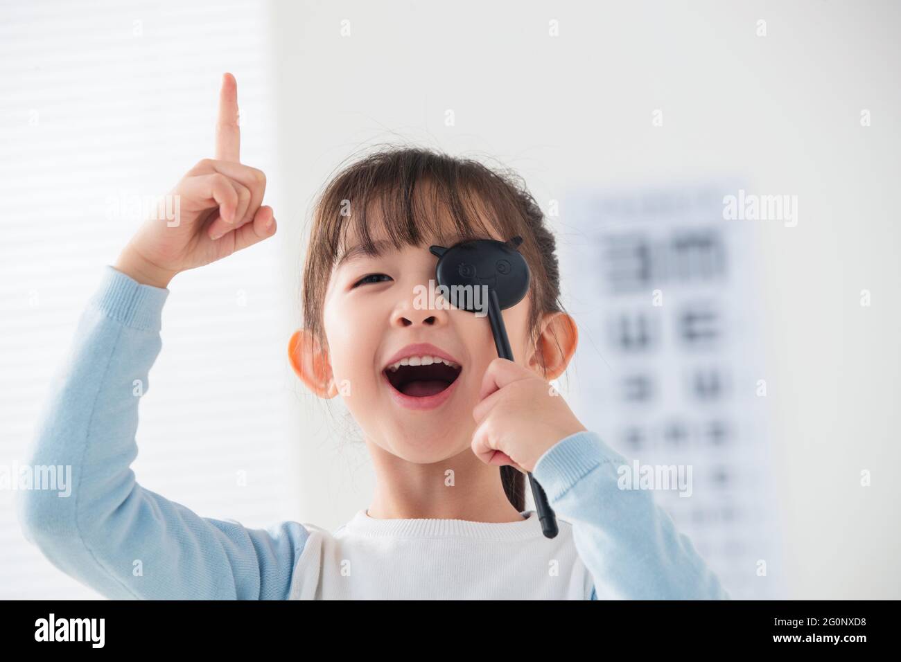 Lovely little girl test visual acuity Stock Photo - Alamy