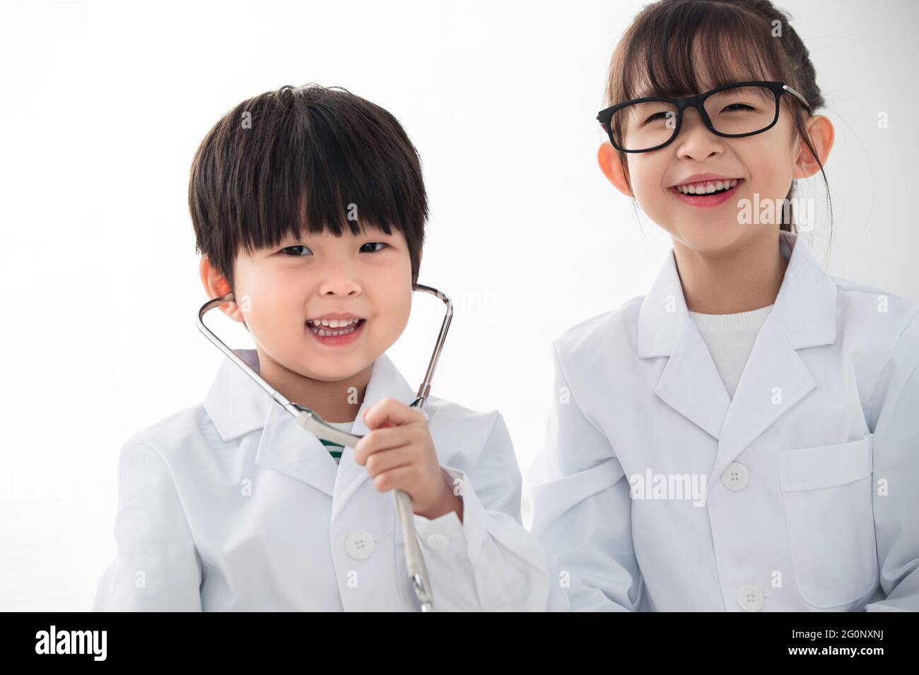 Happy children dressed as a doctor Stock Photo - Alamy