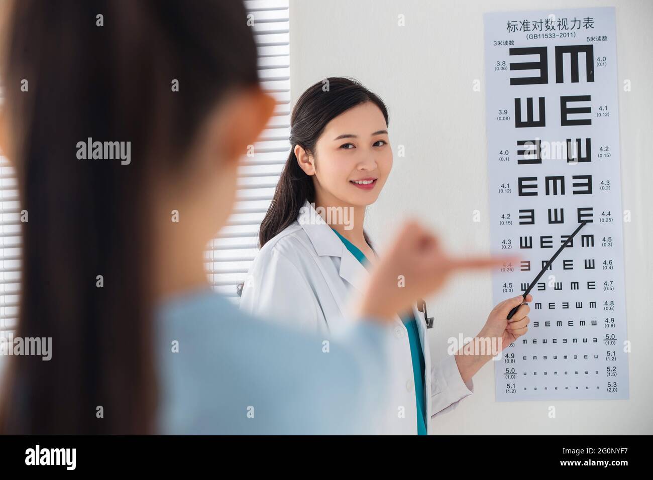 Optometrists to the little girl test visual acuity Stock Photo - Alamy