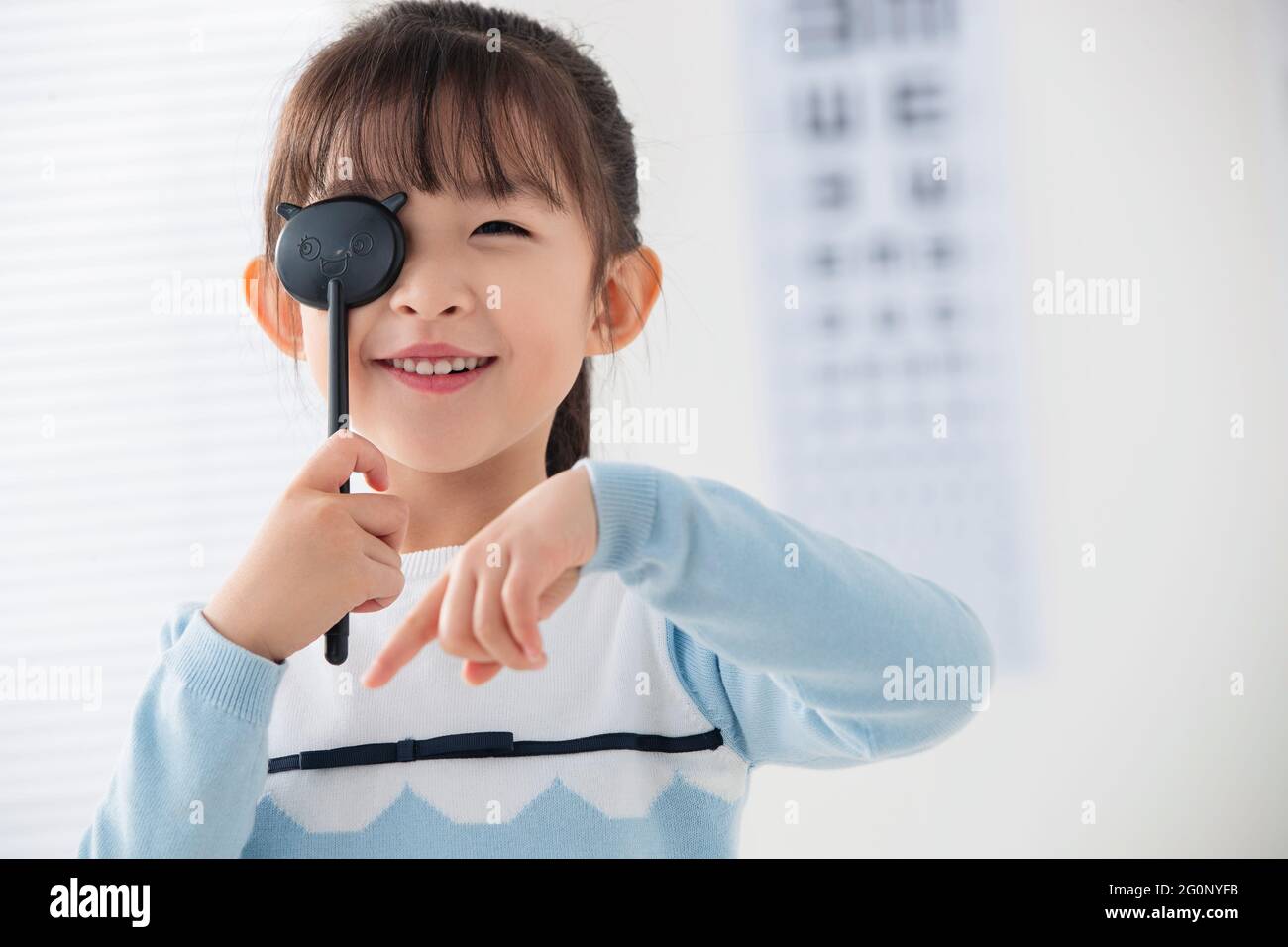Lovely little girl test visual acuity Stock Photo - Alamy