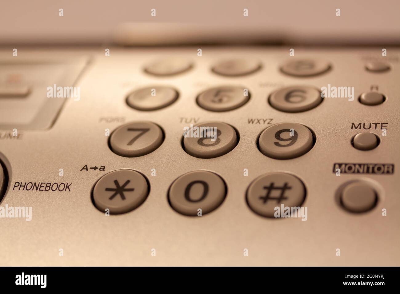 Closeup shot of the buttons of a white telephone with numbers and ...