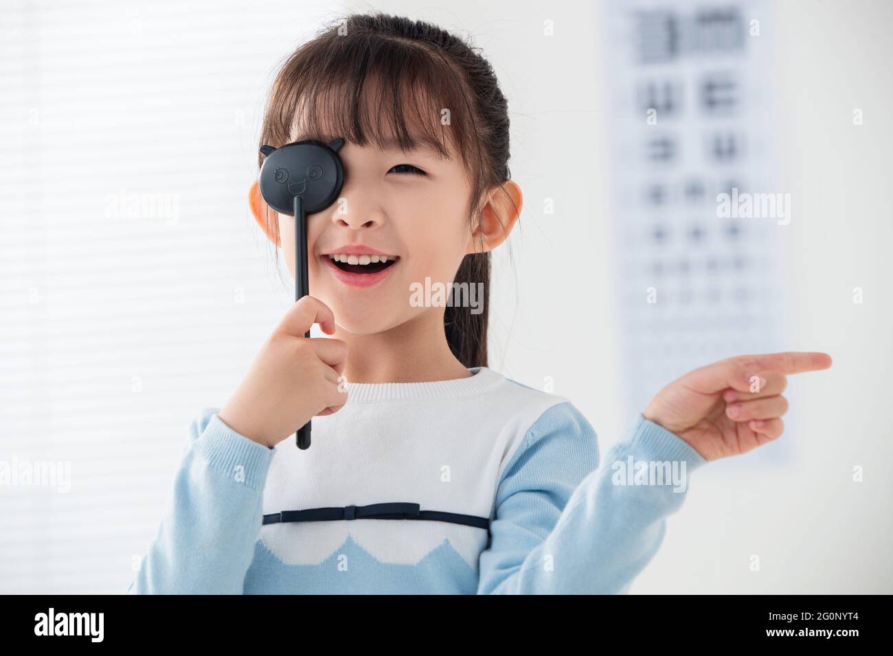 Lovely little girl test visual acuity Stock Photo - Alamy