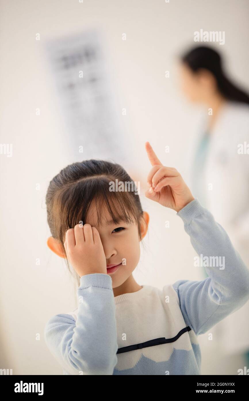 Lovely little girl test visual acuity Stock Photo - Alamy