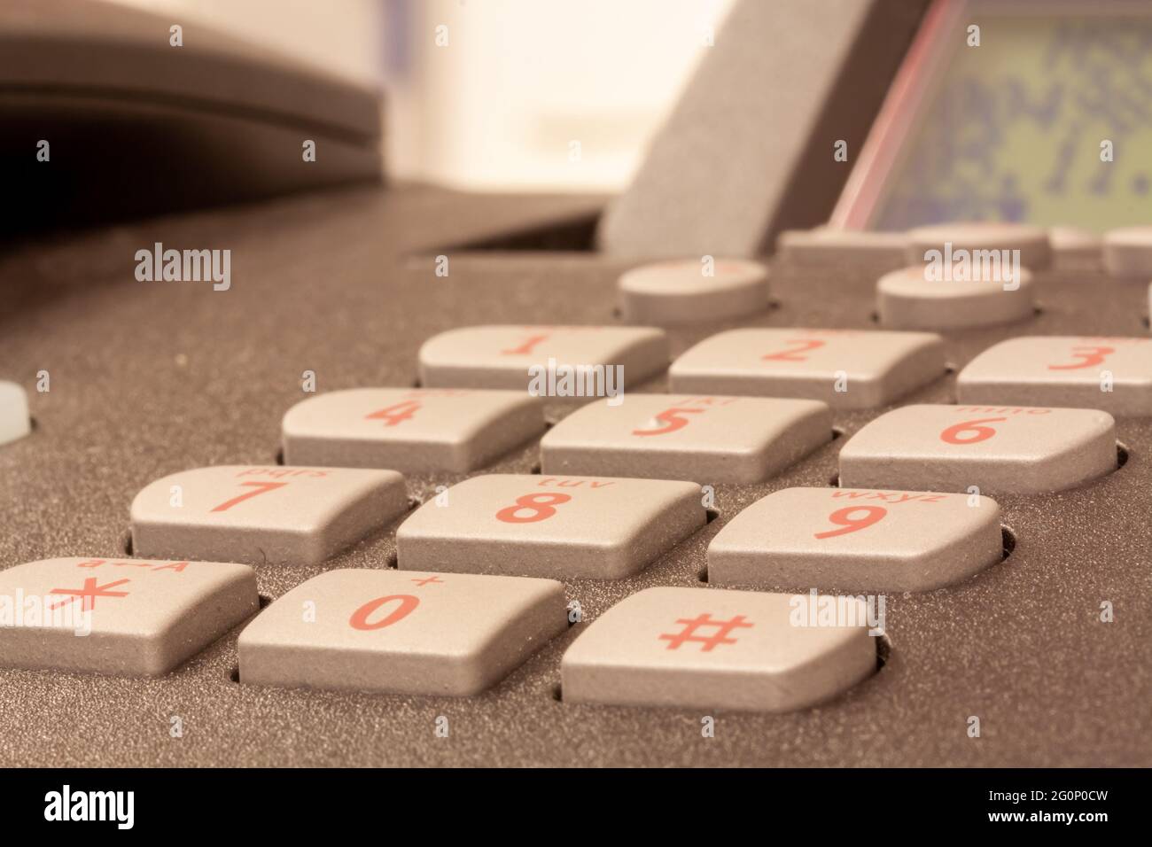 Closeup shot of a grey telephone with a screen on a white background ...