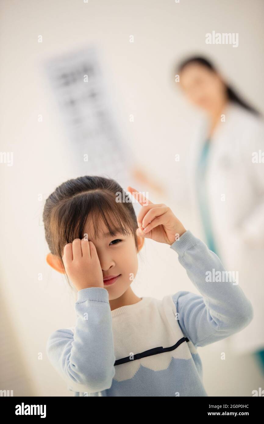 Lovely little girl test visual acuity Stock Photo - Alamy