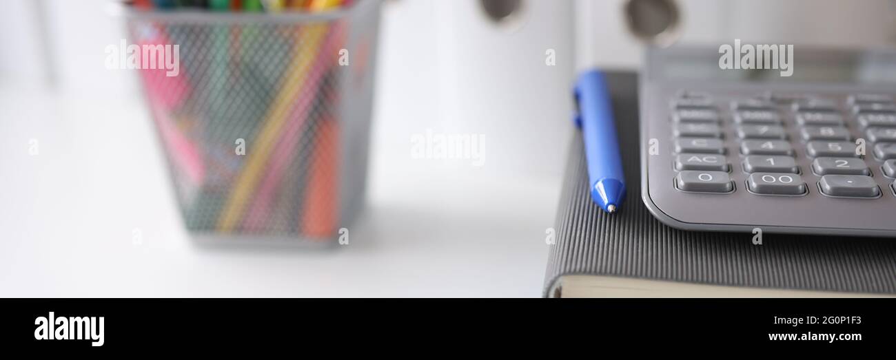 On table are documents diary with a calculator, pencils next to it ...