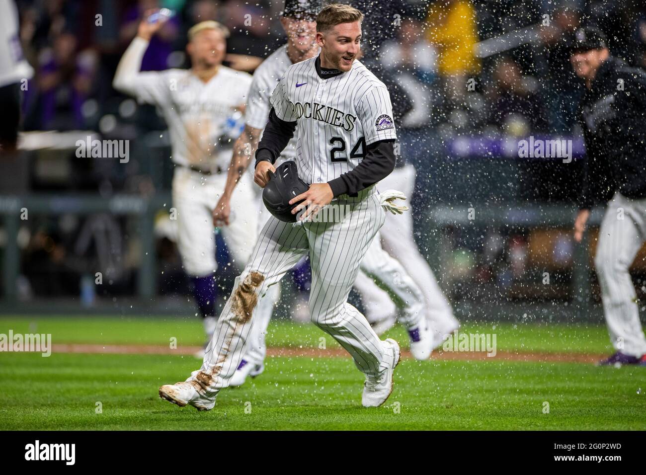 Colorado Rockies infielder Ryan McMahon (24) scores the game winning ...