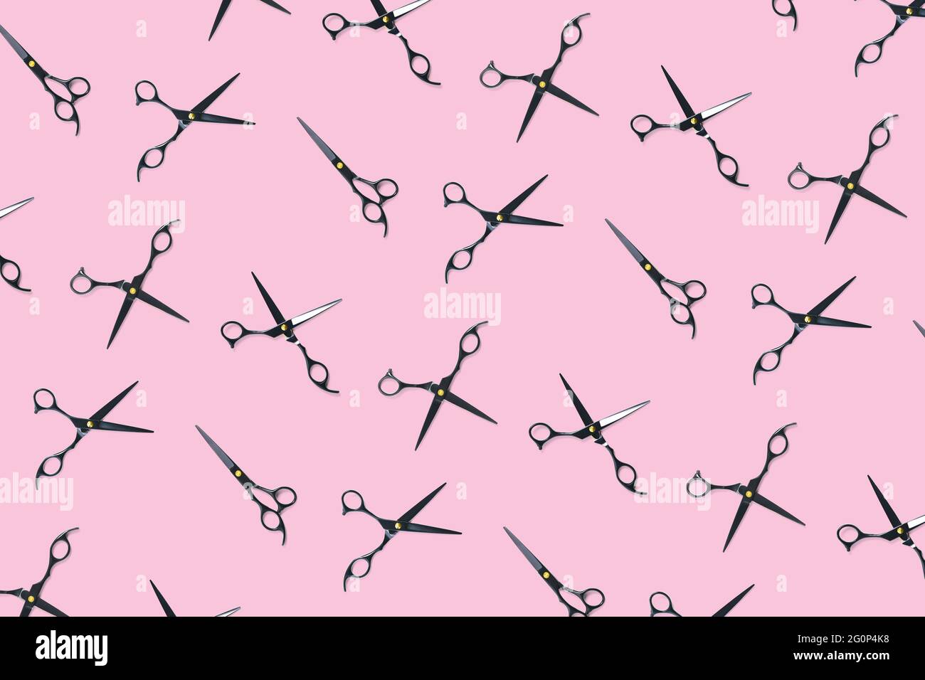 Background made from black scissors. professional hairdresser black scissors isolated on pink ...