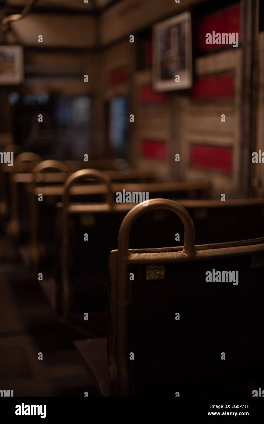 Vertical shot of the interior of an old vintage bus with photos on the ...
