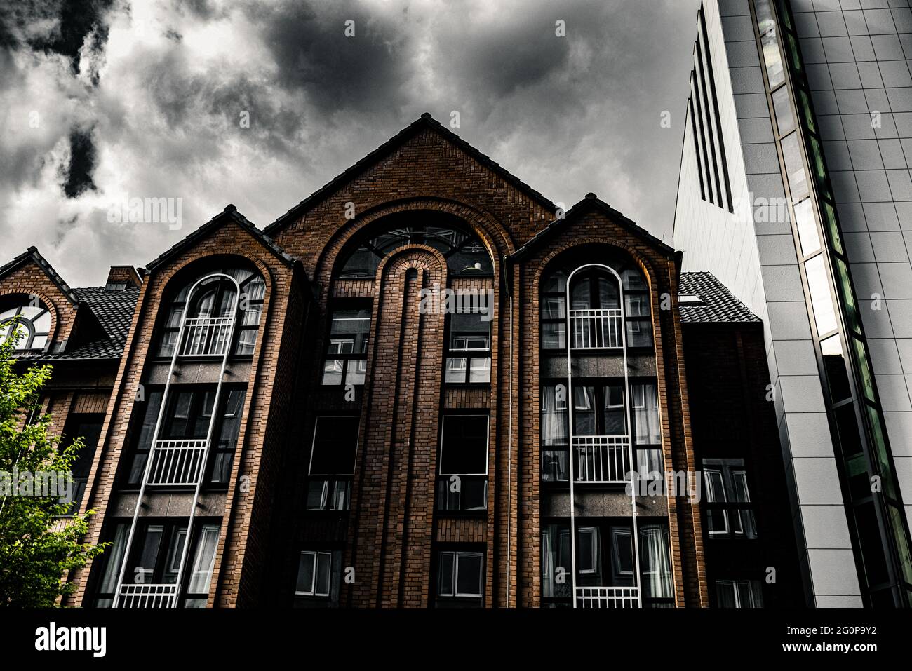 Residential building and an office building under a cloudy sky in the ...