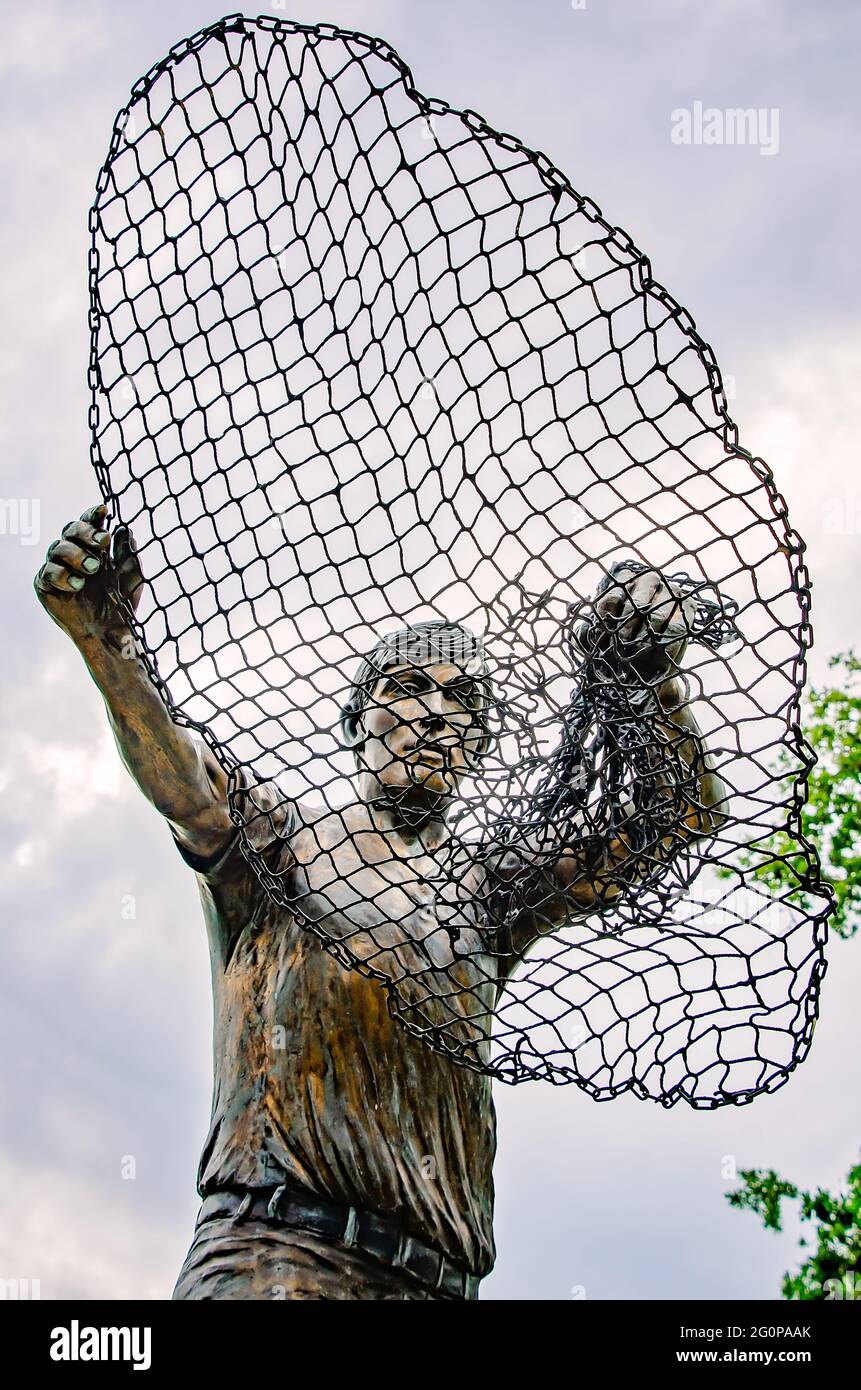 The Golden Fisherman “Casting His Net Into Eternity” statue stands in ...