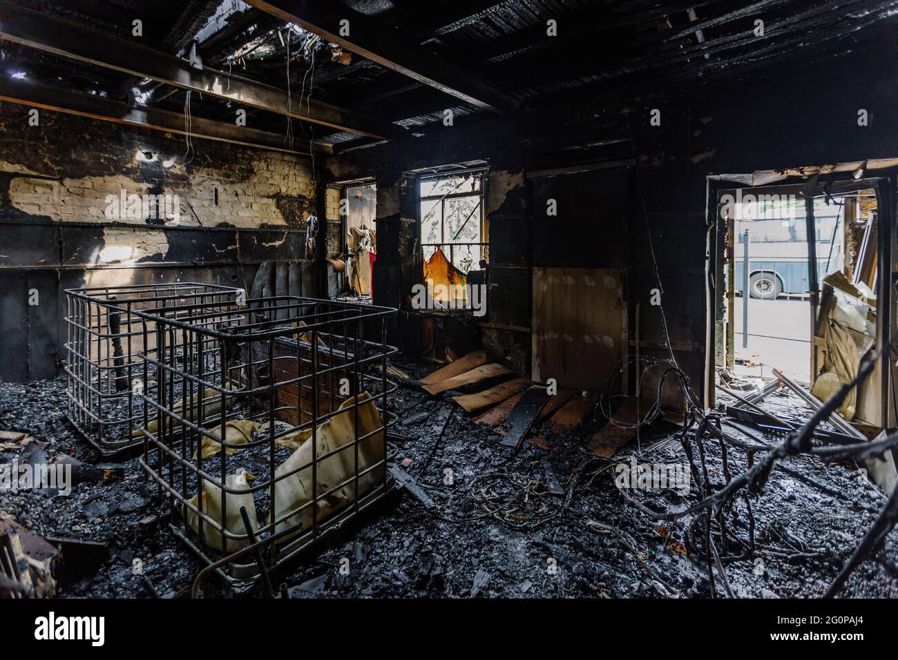 Burnt out shop after fire with charred walls and remains of furniture ...