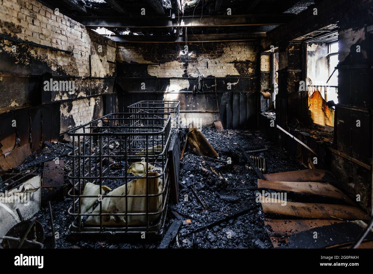 Burnt out shop after fire with charred walls and remains of furniture ...