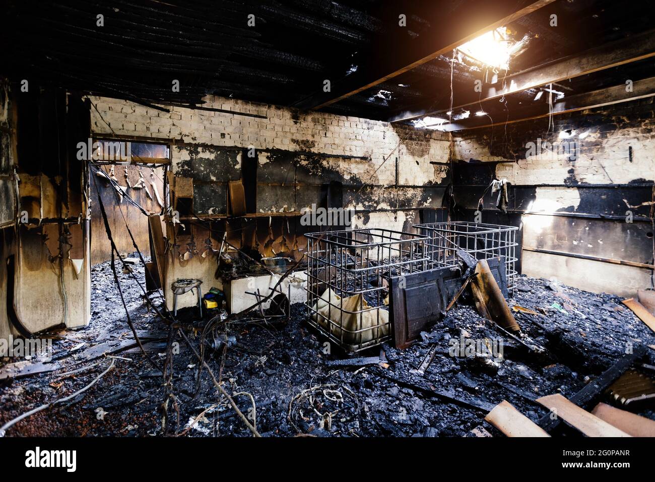Burnt out shop after fire with charred walls and remains of furniture ...
