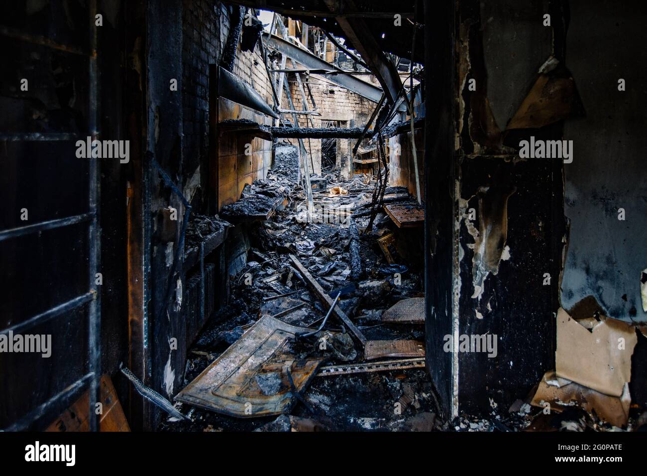 Burnt out shop after fire with charred walls and remains of furniture ...
