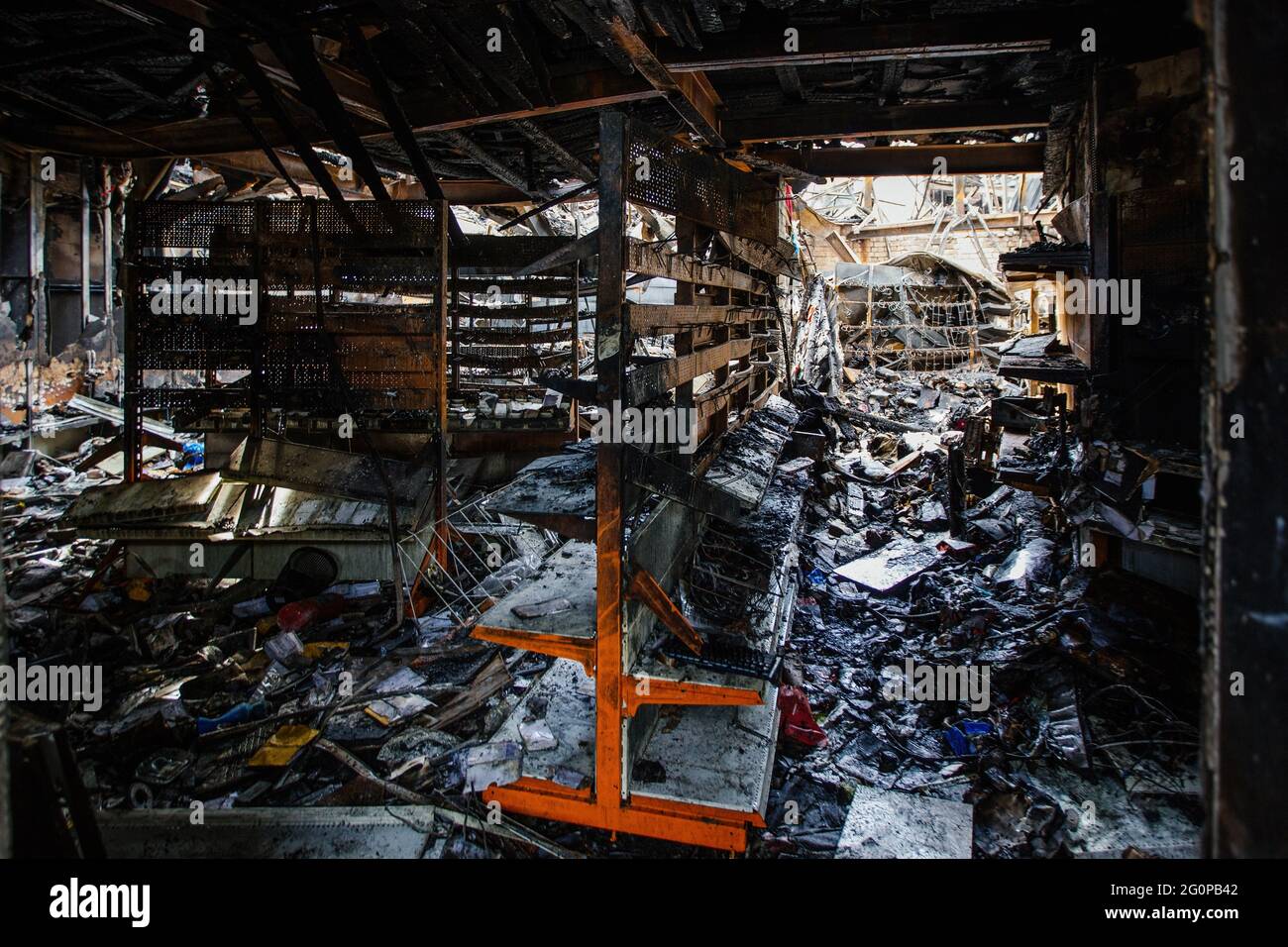 Burnt out shop after fire with charred walls and remains of furniture ...