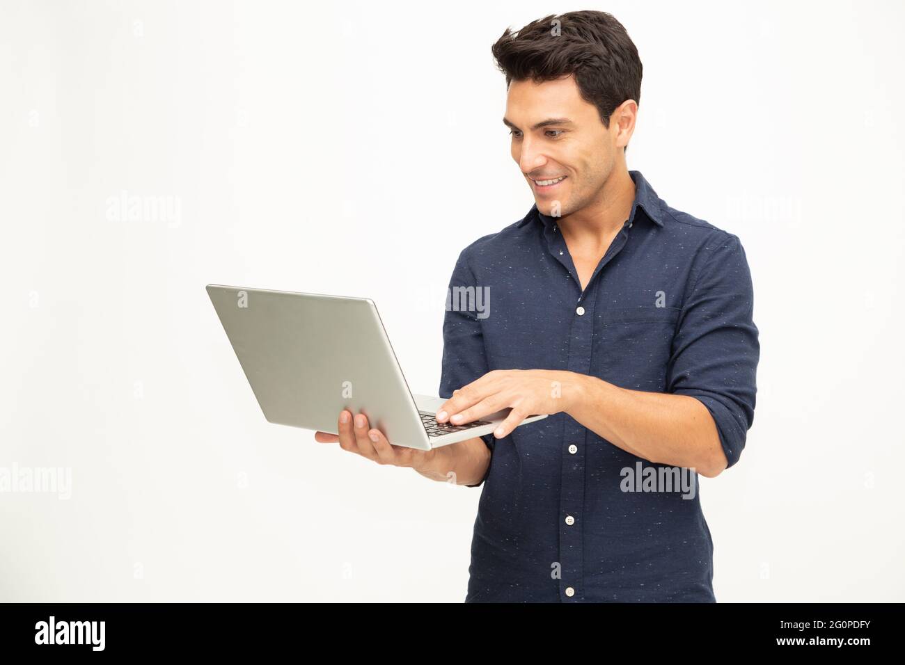 Portrait of an excited man holding laptop computer and celebrating ...