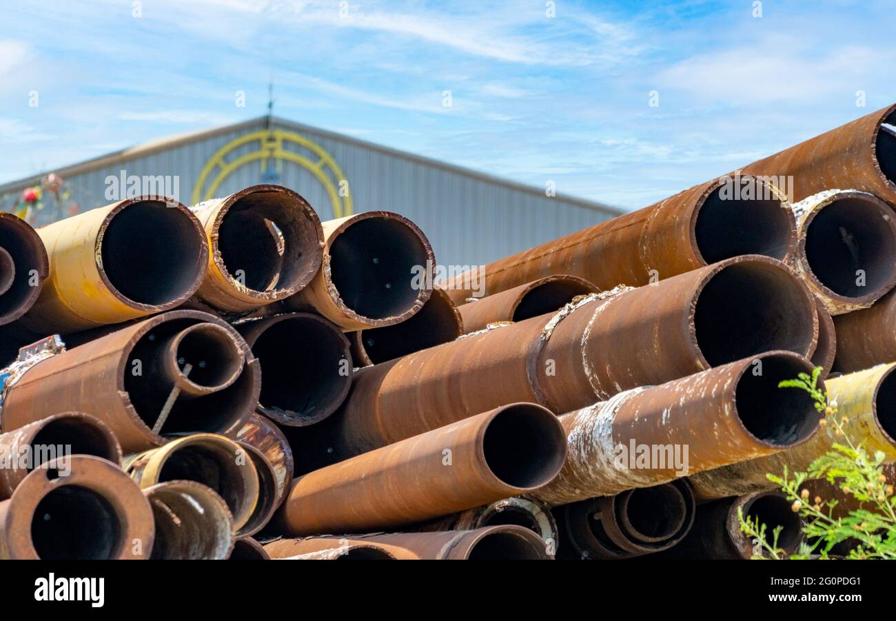Pile of old rusty round metal industrial pipe. Steel pipe stack at ...
