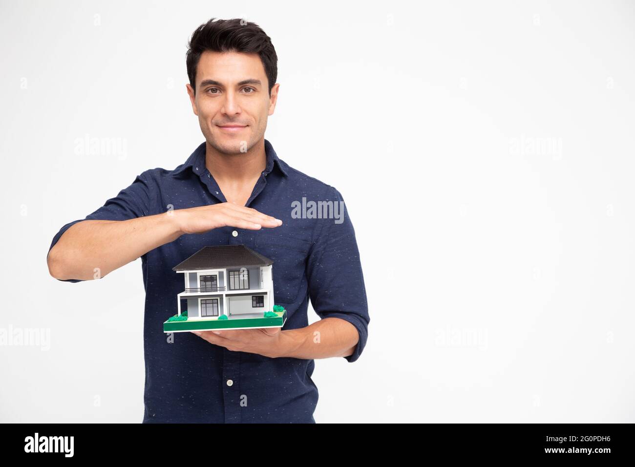 Handsome young Caucasian man inspector holding single home, Home ...