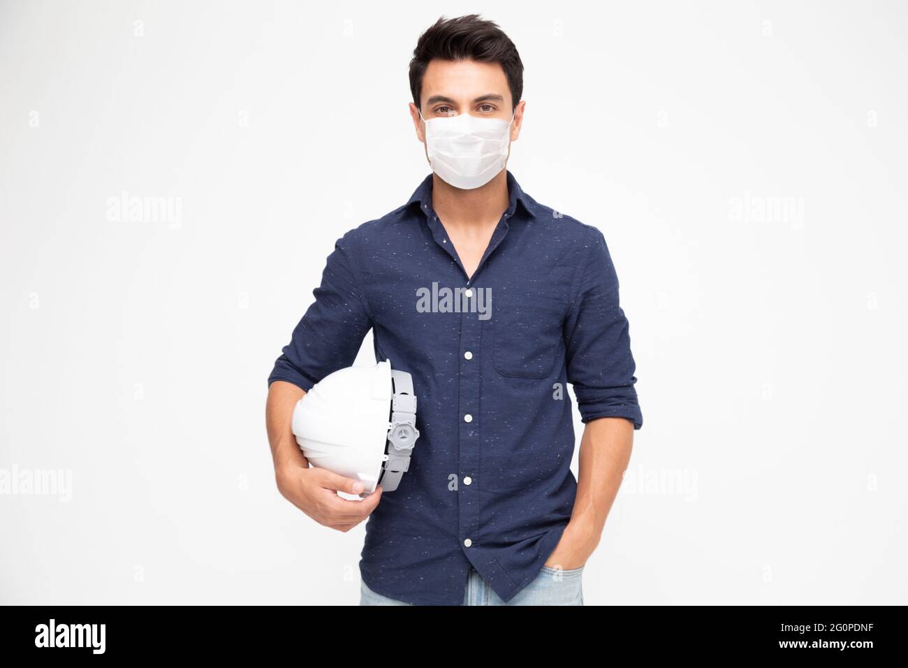 Handsome man industrial engineer holding a white helmet and wearing ...