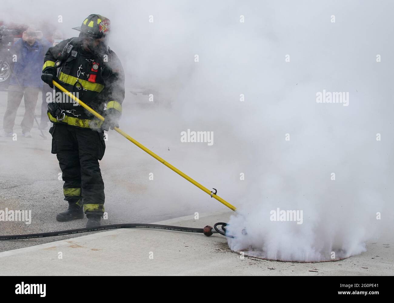 St. Louis firefighter Dan Fuchs uses carbon dioxide to simulate the ...