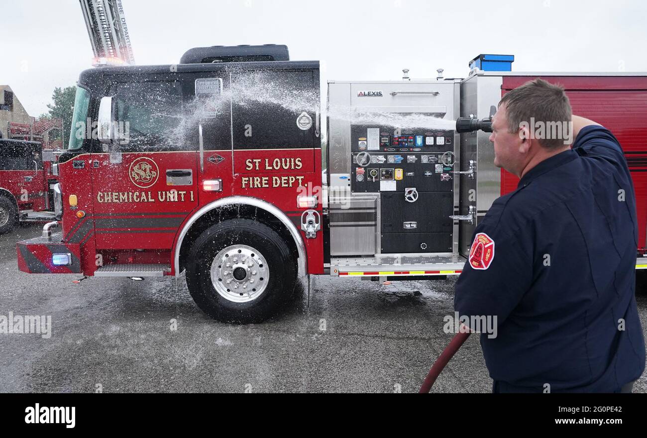 St. Louis firefighter Steve Gulley uses a hose to wash off foam during ...