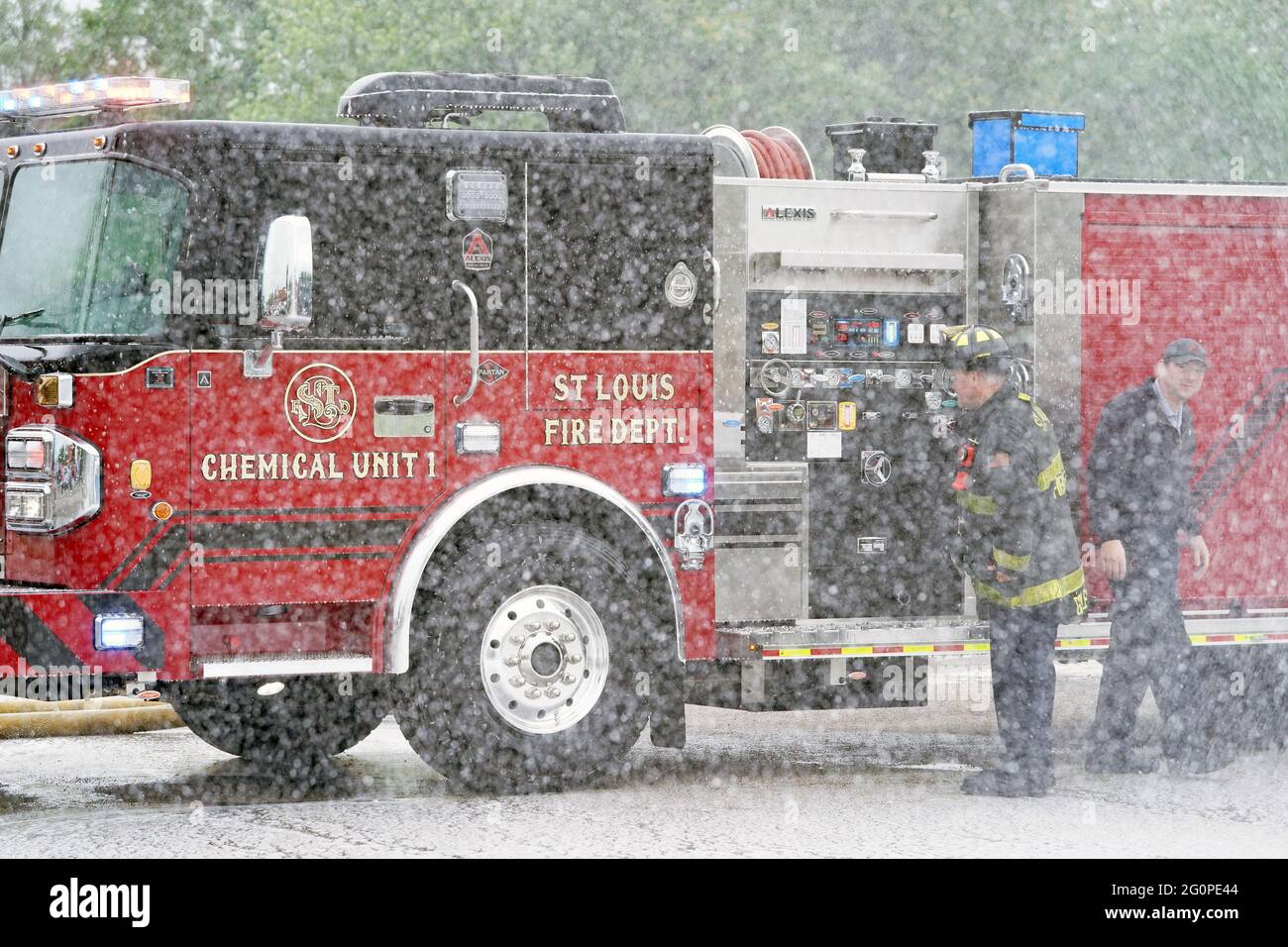 St. Louis firefighters monitor a spray of foam from a new chemical ...