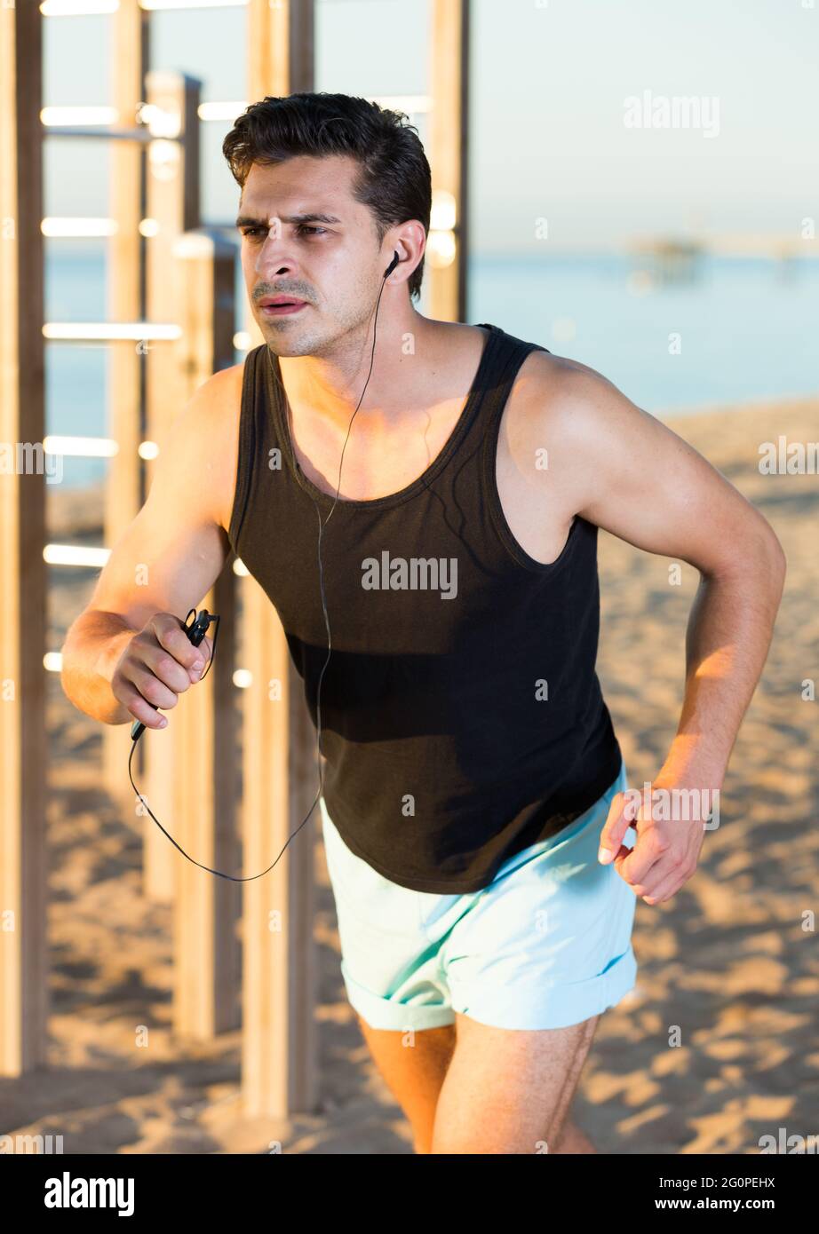 Man jogging on beach Stock Photo - Alamy
