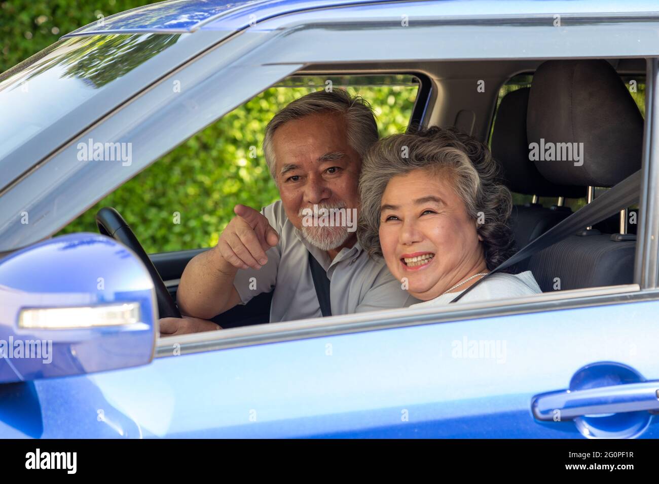 Asian couple driving car happily hi-res stock photography and images ...