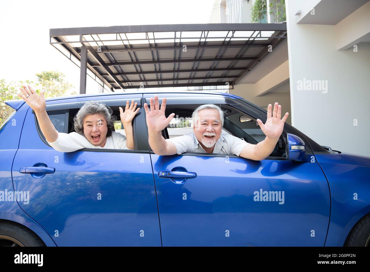 Senior couple in car enjoying trip and smiling happy with travel on the ...