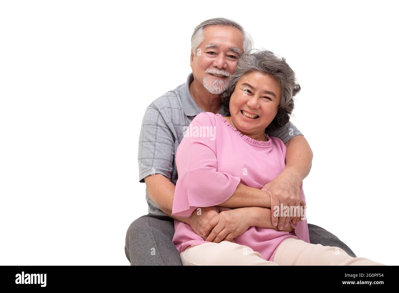 Asian Senior Couple Sitting And Hugging Together Isolated On White